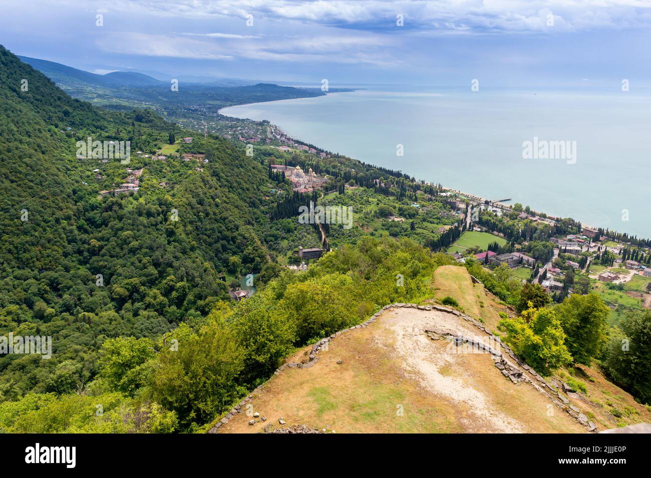 Amazing epic shot of young man hiker stand on top of mountain after ...