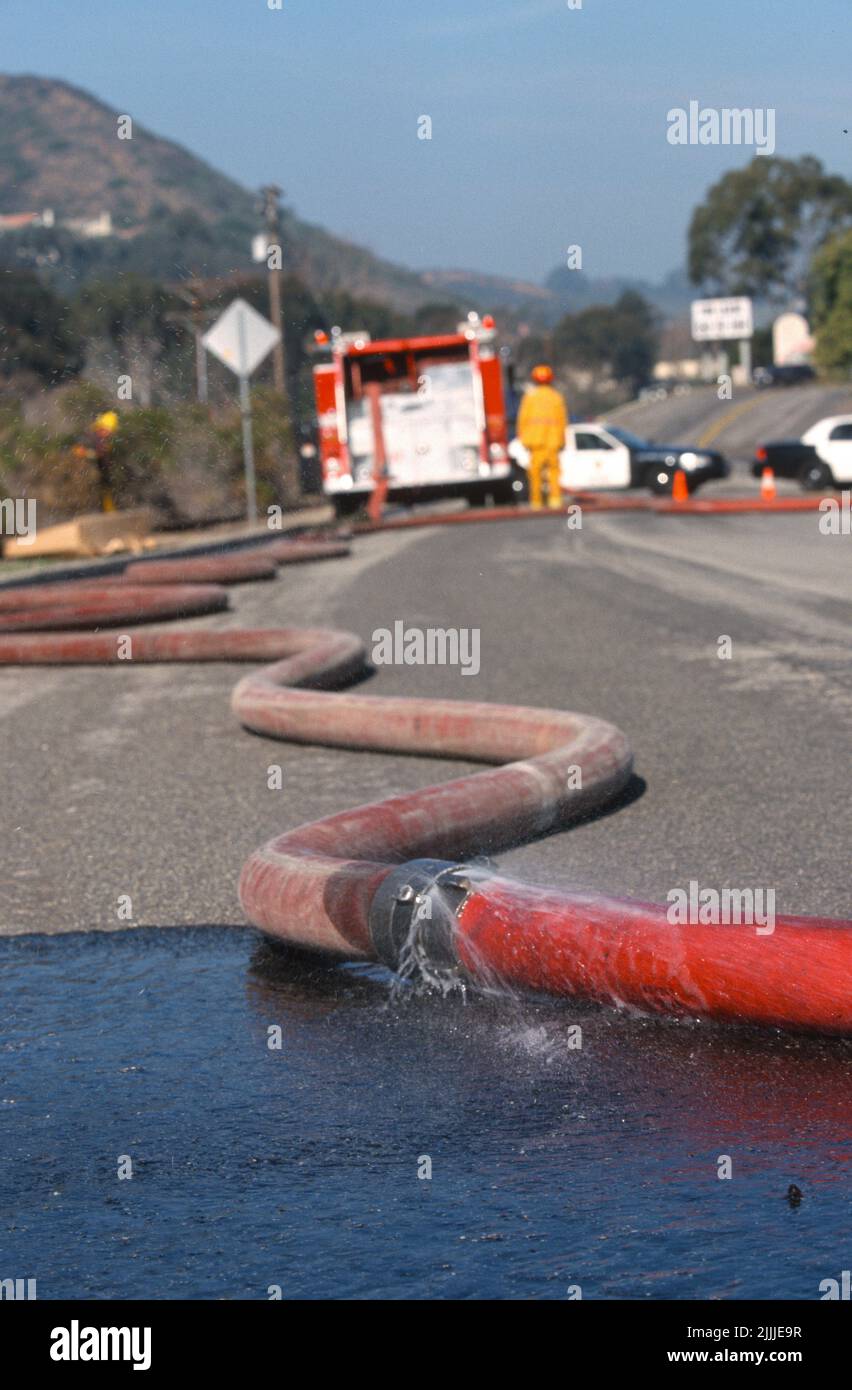 Four-inch charged supply line supplies water to SDFD Engine 27 at a ...