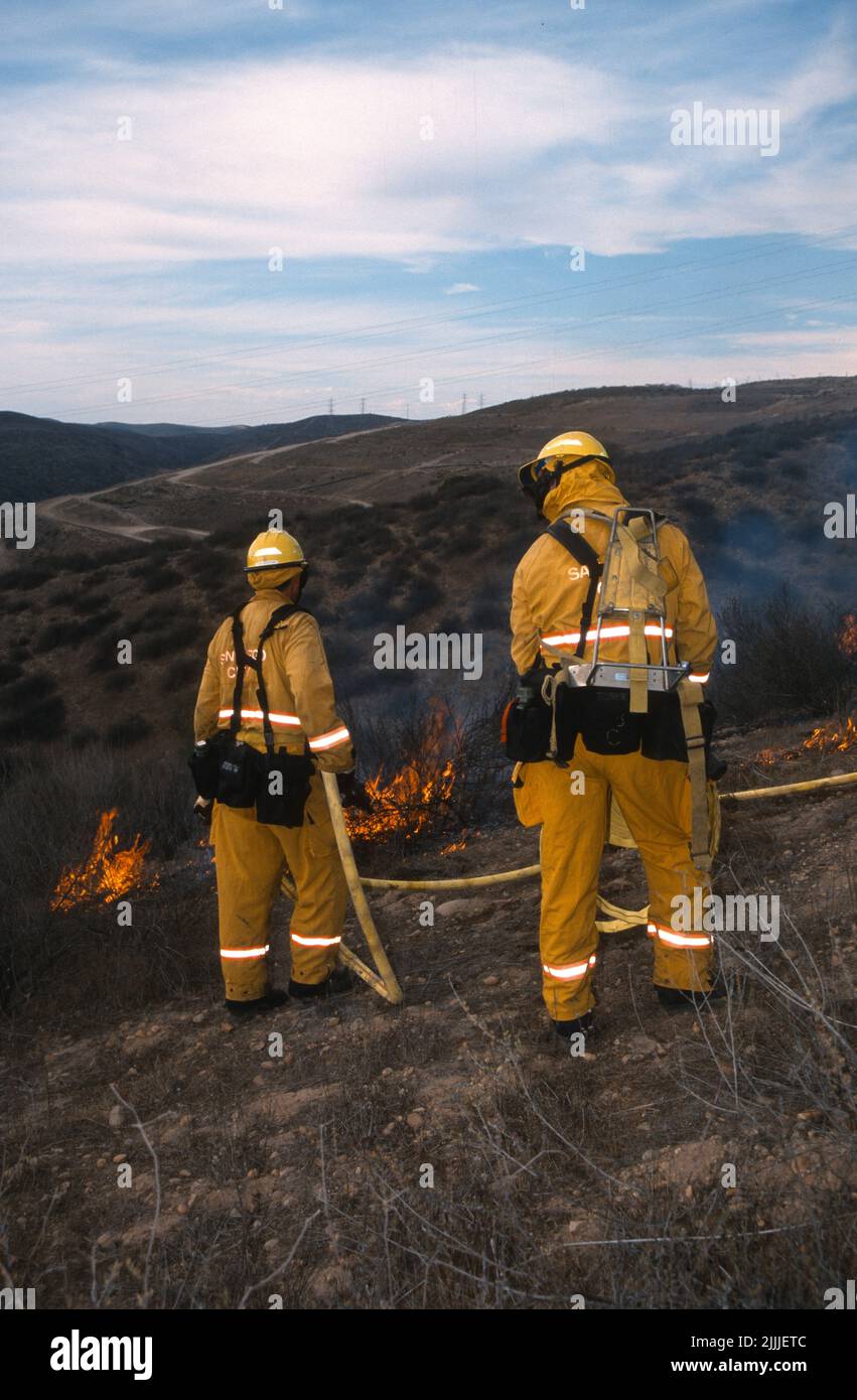 Firefighters working the flank of a fire in San Diego, California Stock ...