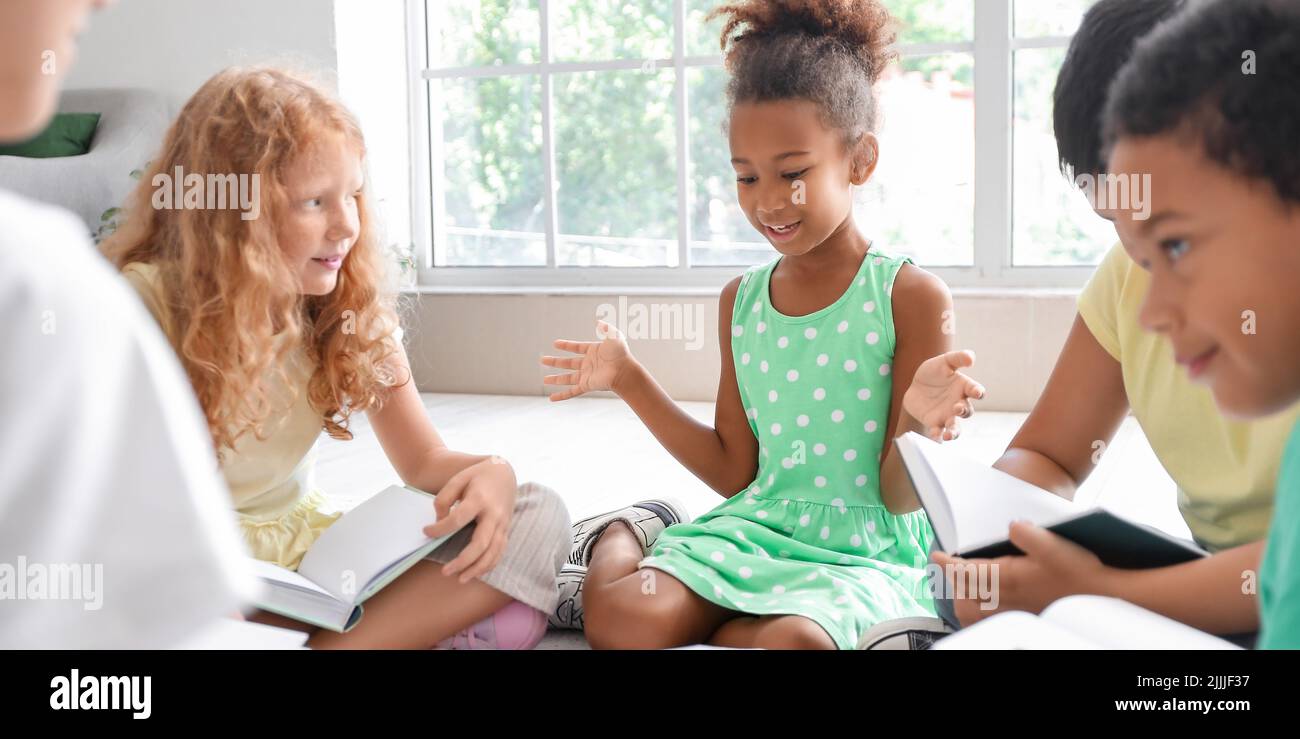 Little children reading books indoors Stock Photo - Alamy