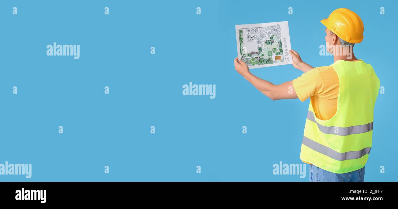 Male landscape designer with new project on blue background with space ...