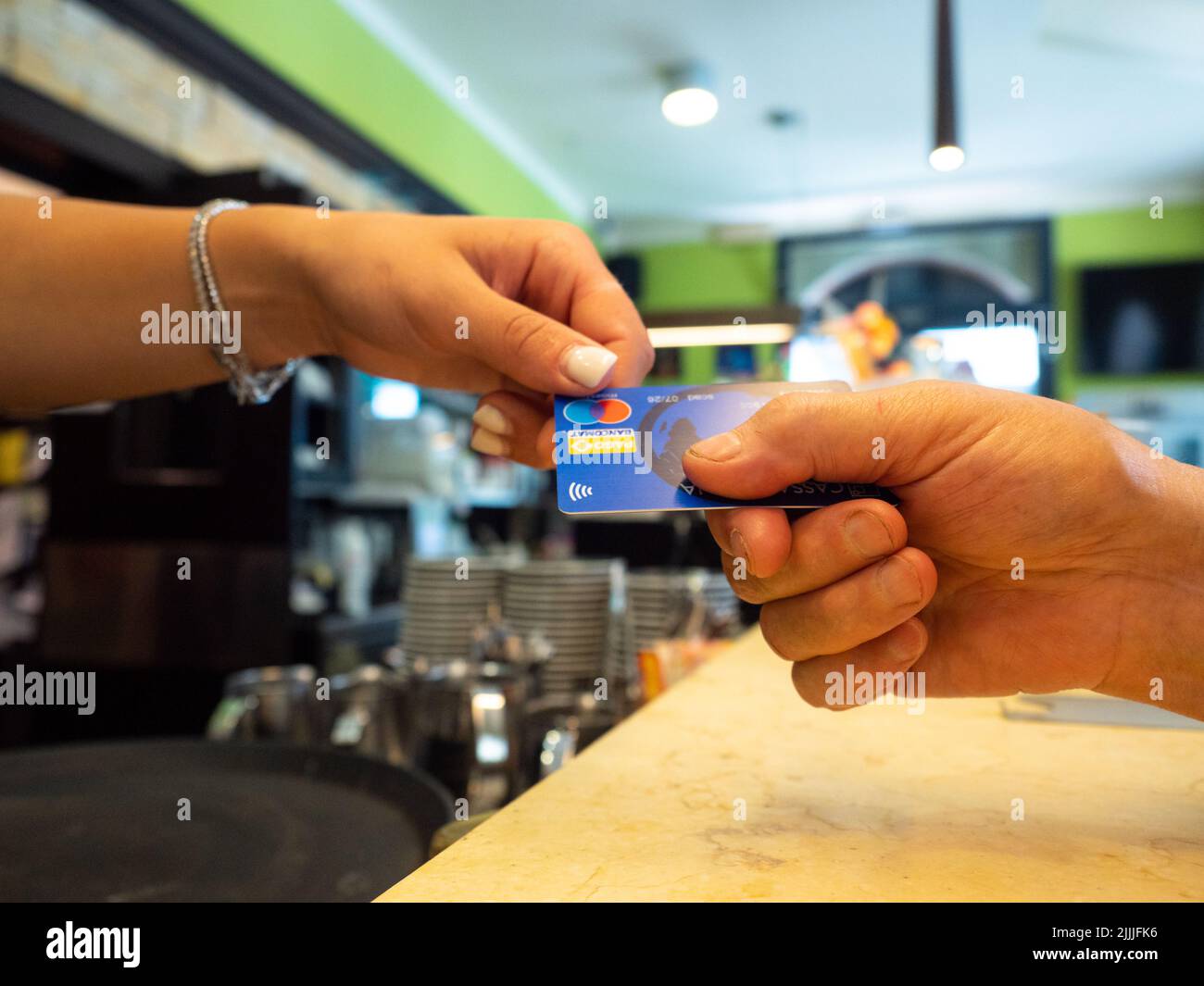 customer pays for a drink in a bar with credit card Stock Photo - Alamy