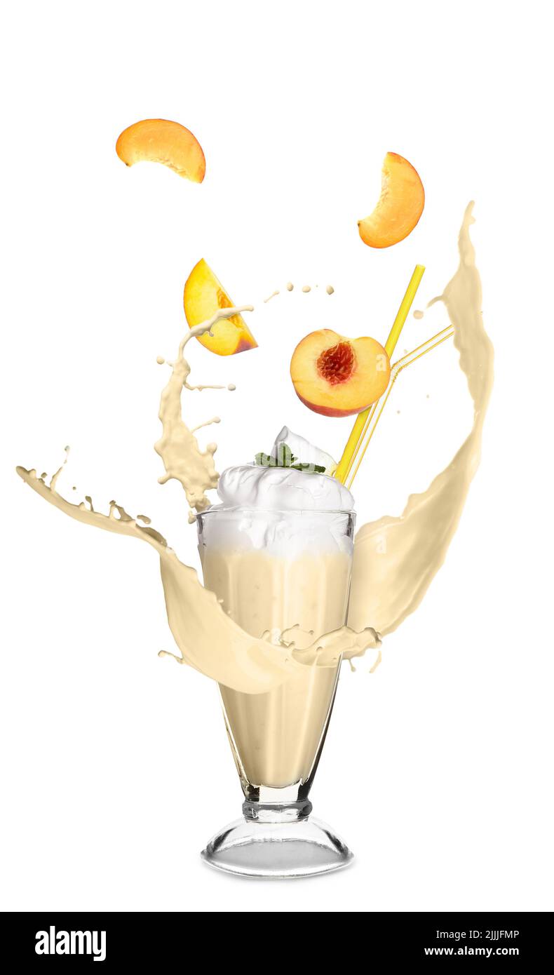 Glass of tasty peach milkshake with splashes on white background Stock ...