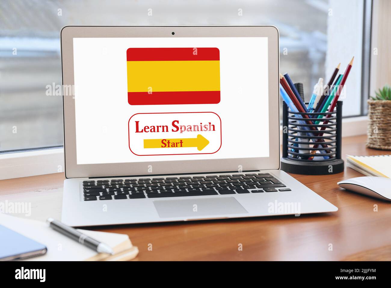 Modern laptop with text LEARN SPANISH on screen at workplace Stock ...