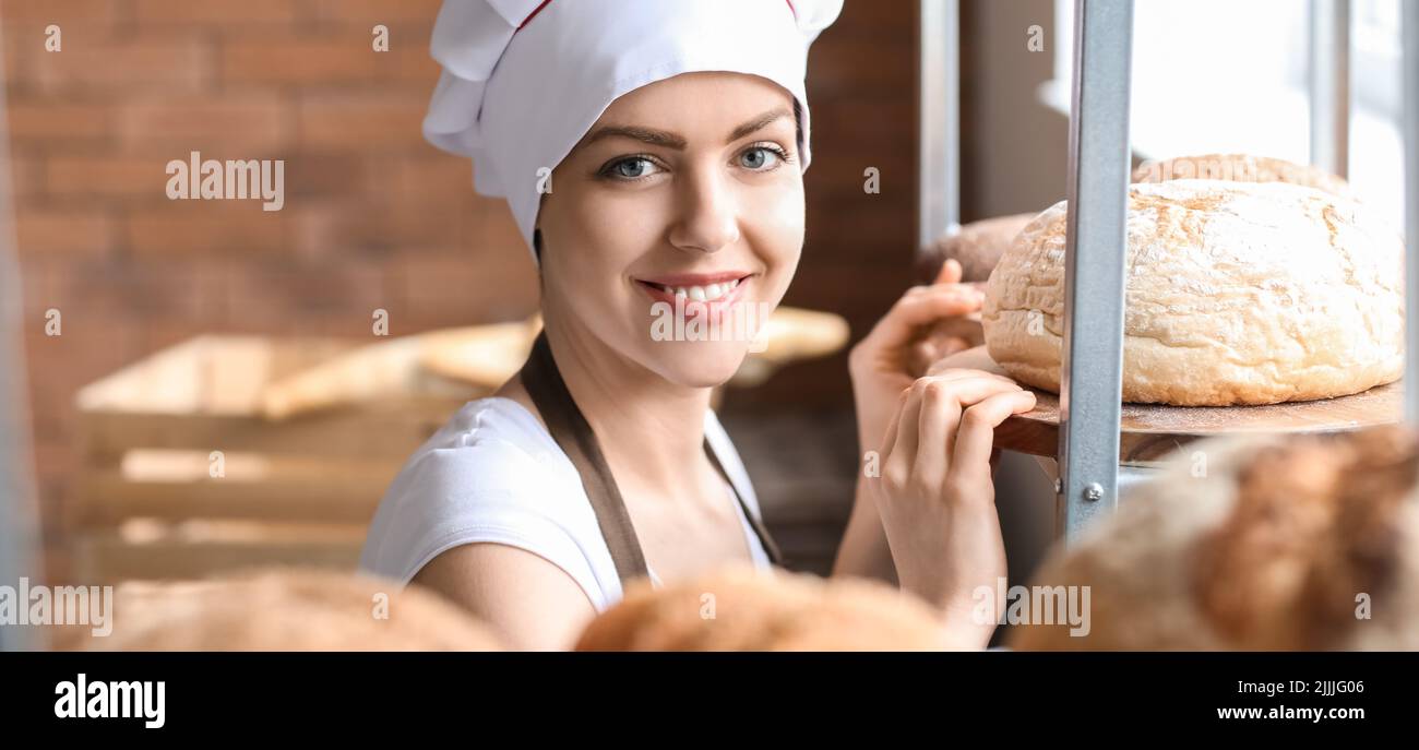 Female baker with tasty bread in kitchen Stock Photo - Alamy