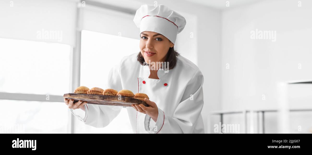Female baker with tasty pastry in kitchen Stock Photo - Alamy