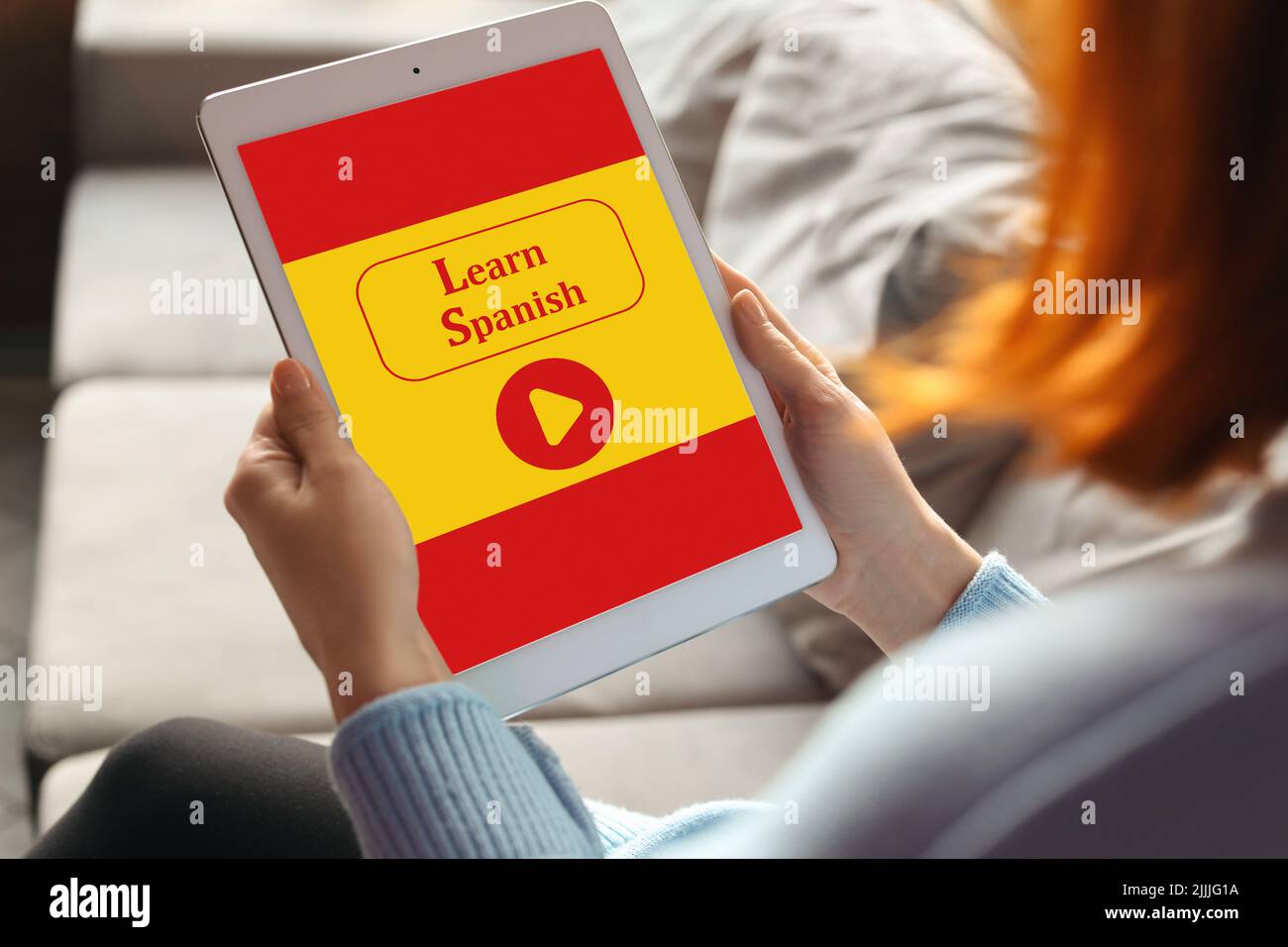 Woman with tablet computer learning Spanish at home Stock Photo - Alamy