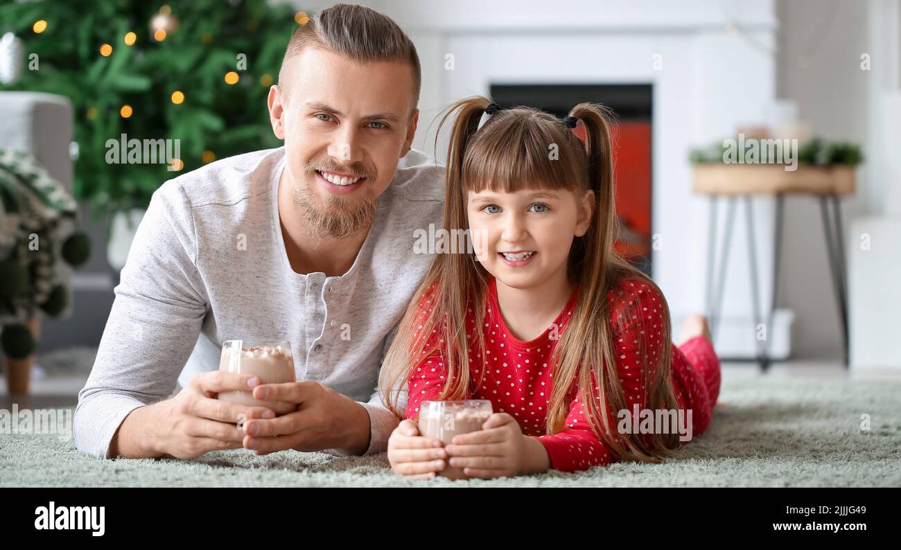 Happy father and daughter drinking hot chocolate at home on Christmas ...