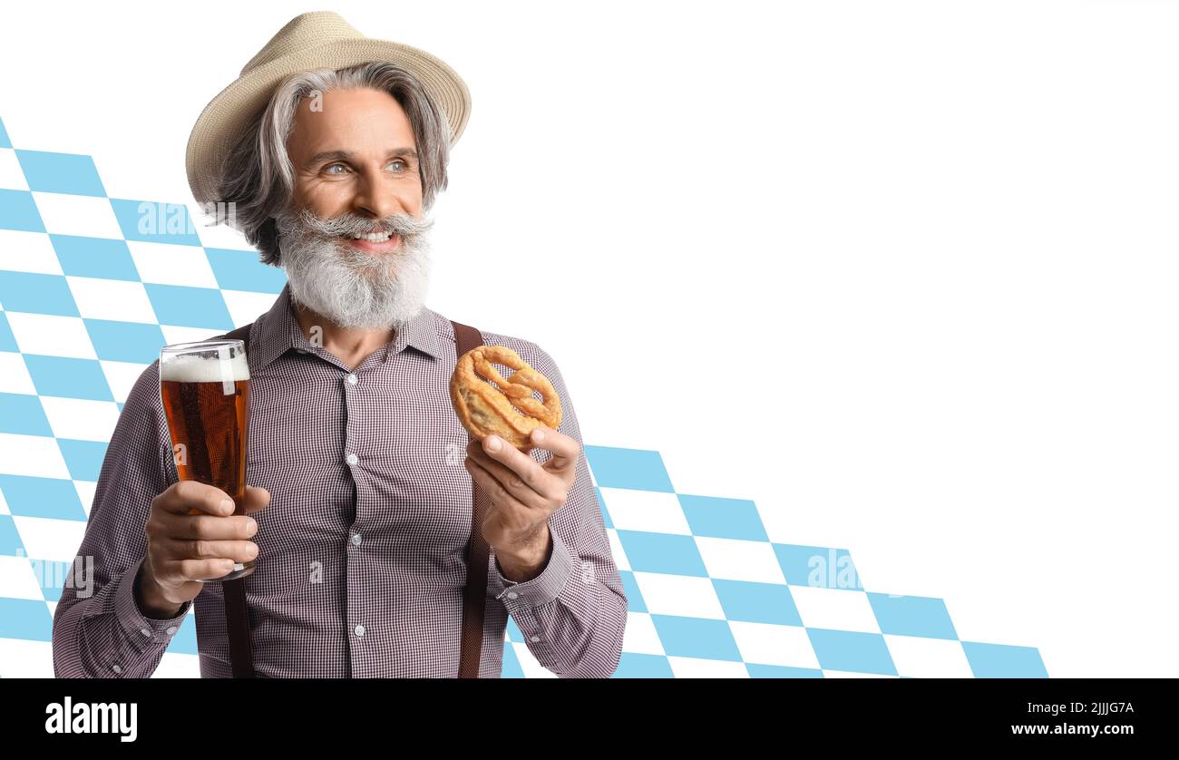 Senior man in traditional German clothes, with beer and pretzel on ...