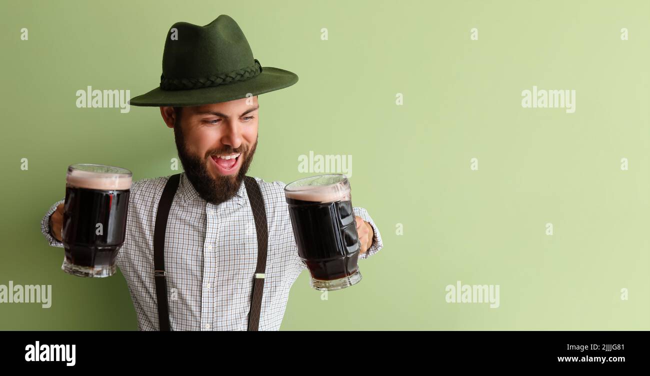 Funny man with big head in traditional German clothes and with beer on ...