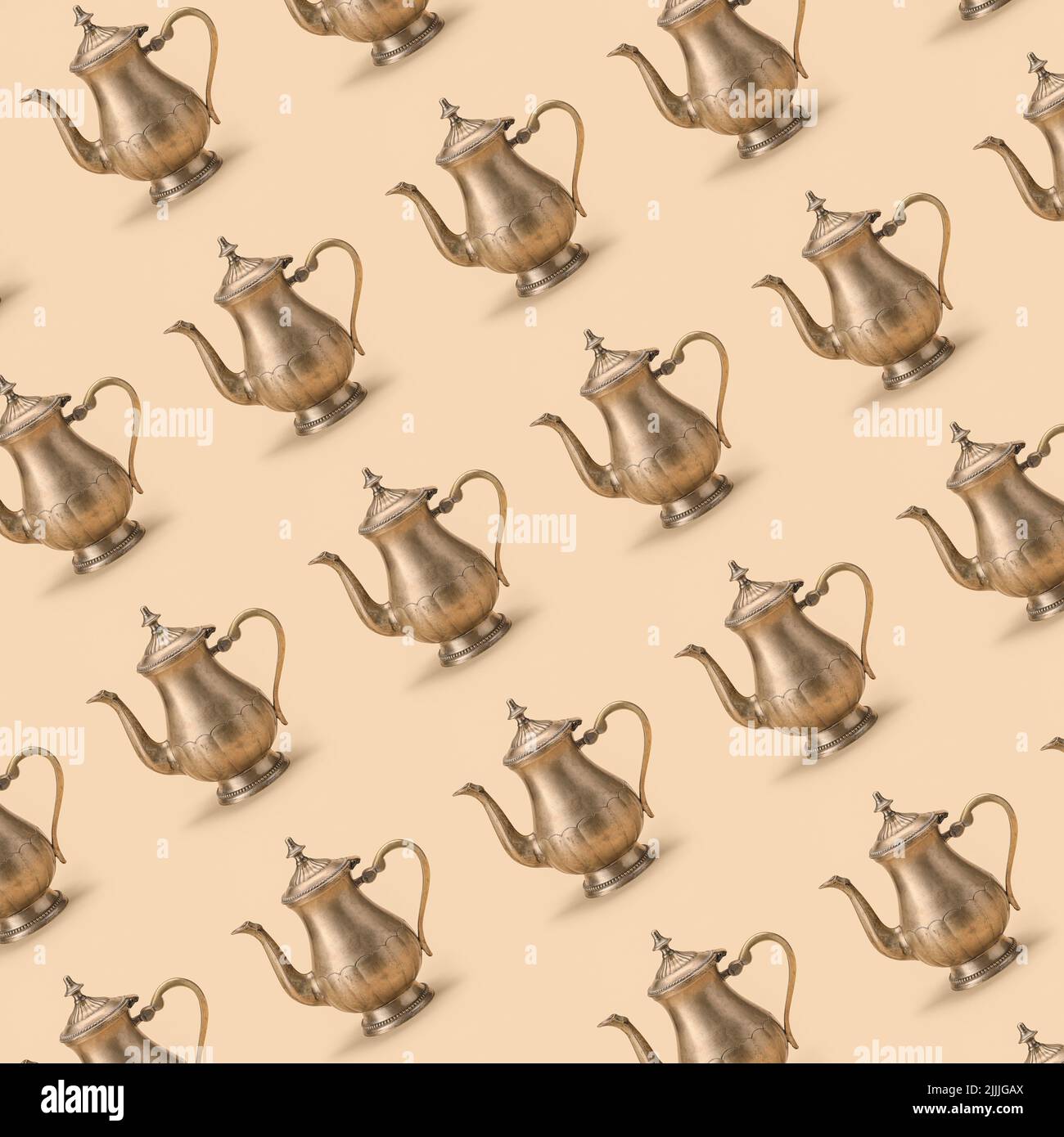 Stylish teapots on beige background Stock Photo - Alamy