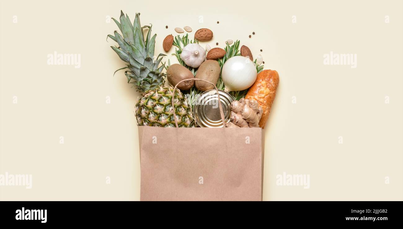 Paper bag with different fresh products on light background Stock Photo ...