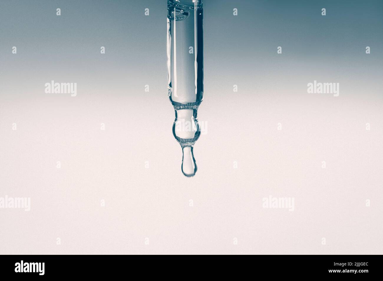 Liquid serum and dropper on a gradient background. Frontal view. Serum ...