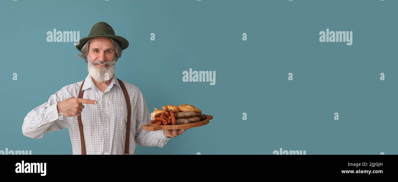 Handsome mature man in traditional German clothes and with snacks on ...