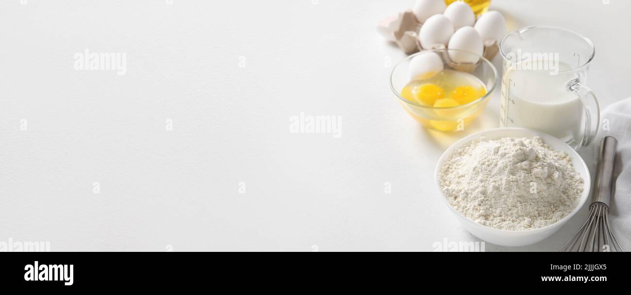 Different ingredients for baking on white background with space for ...