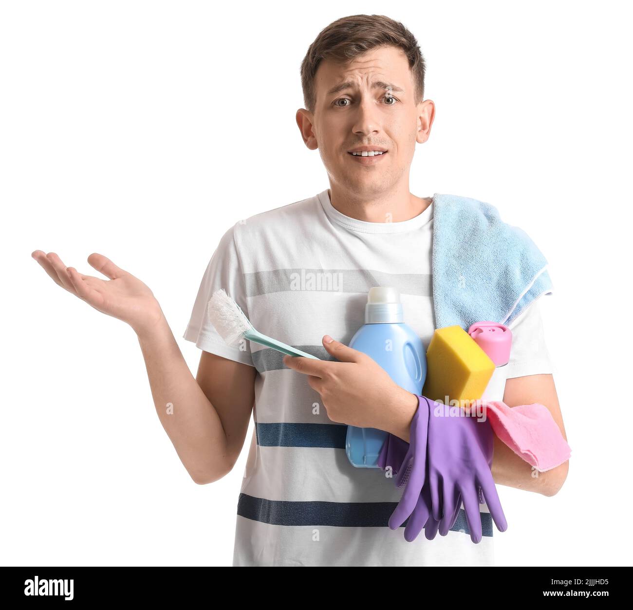 Confused young man with cleaning supplies on white background Stock ...