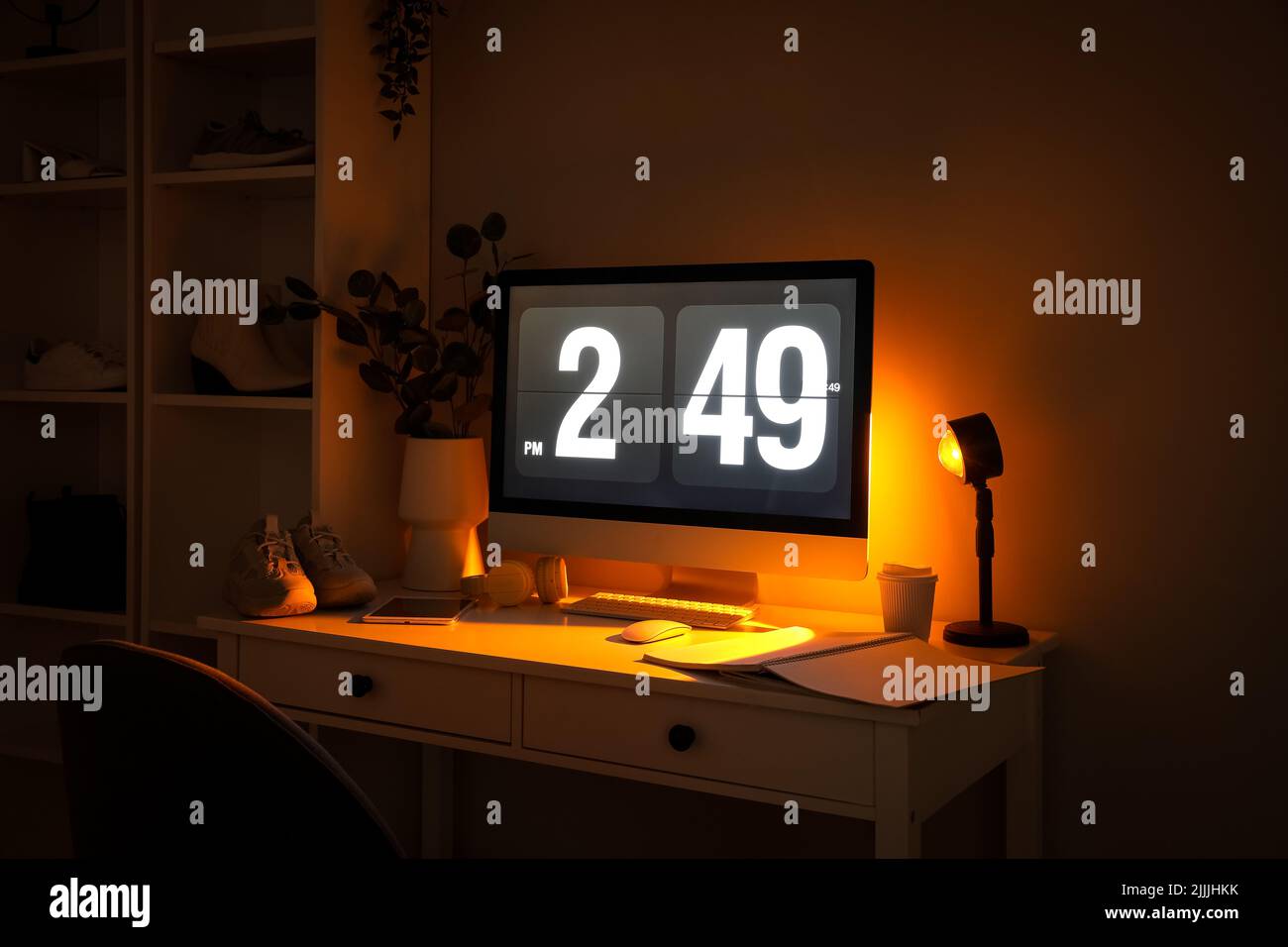 Workplace with modern computer in dark room Stock Photo - Alamy