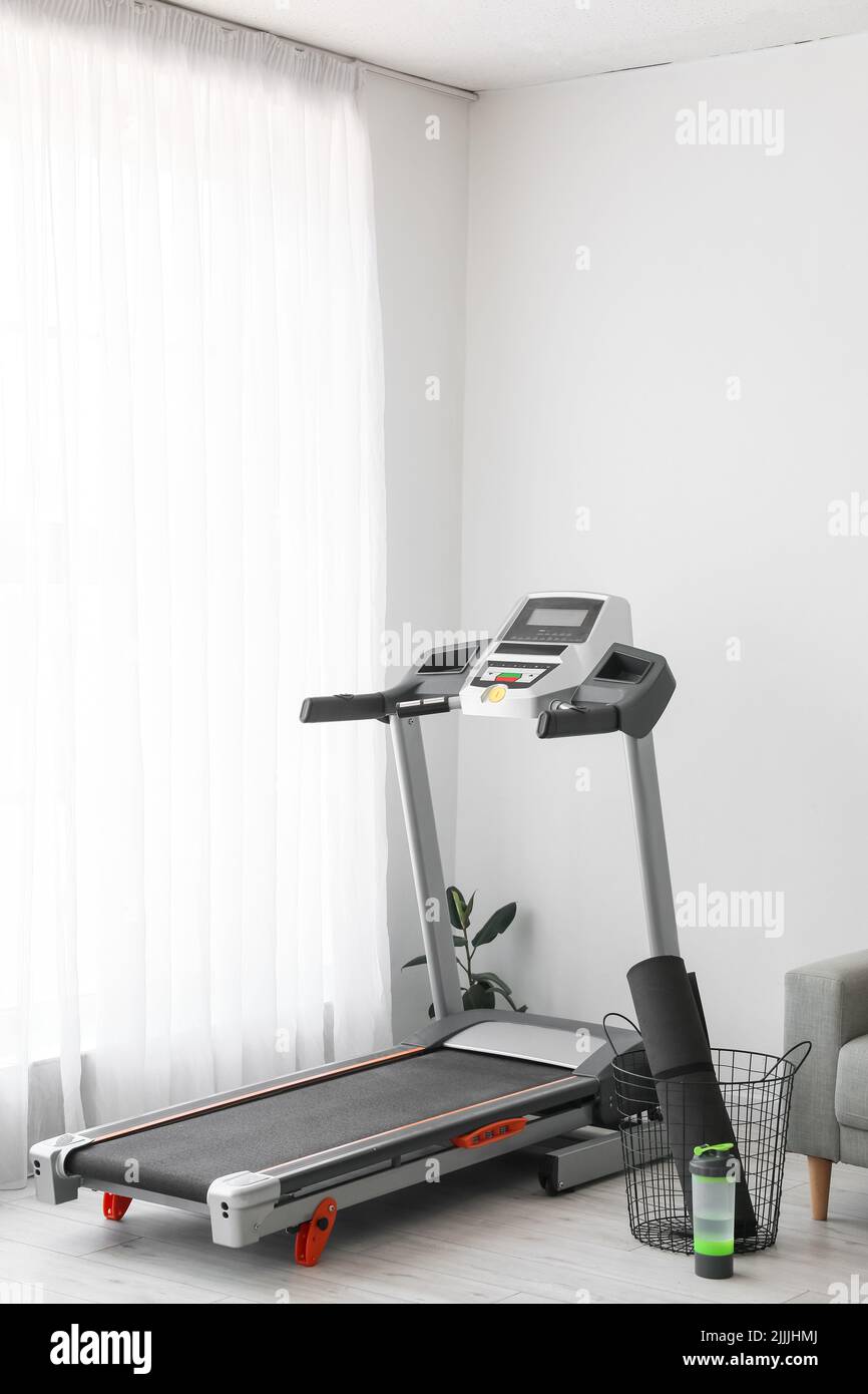 Modern treadmill in interior of light living room Stock Photo - Alamy