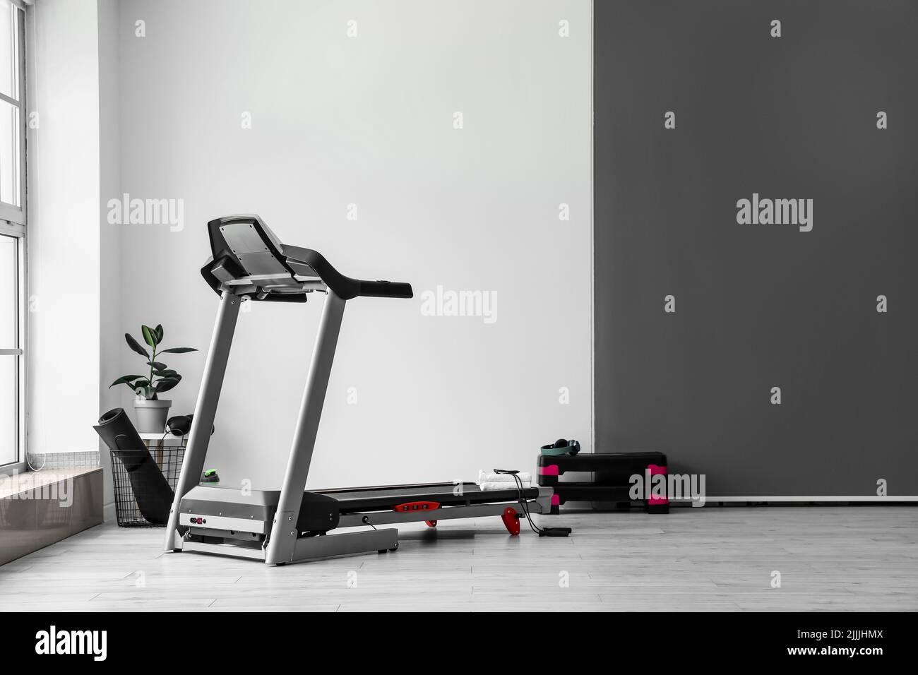 Modern treadmill with towels and skipping room in gym Stock Photo - Alamy