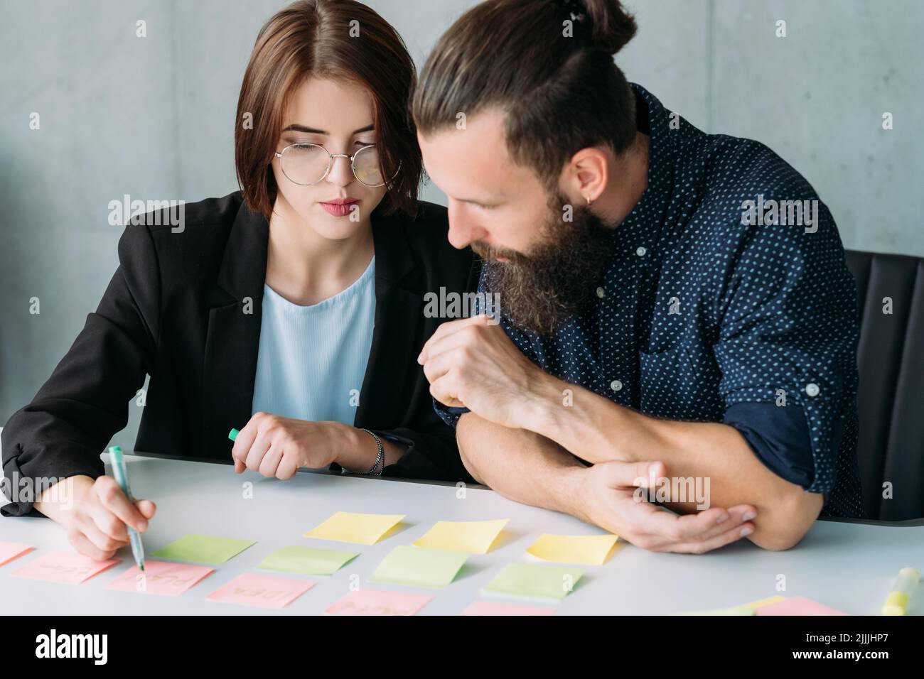 coworkers brainstorming marketing strategy notes Stock Photo - Alamy