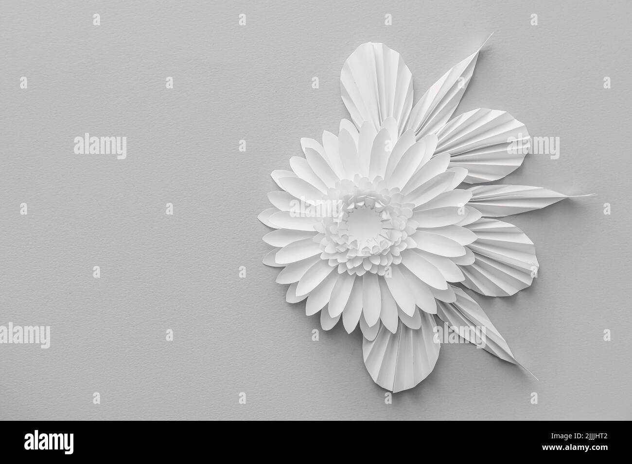 Composition with paper flower and leaves on grey background Stock Photo ...