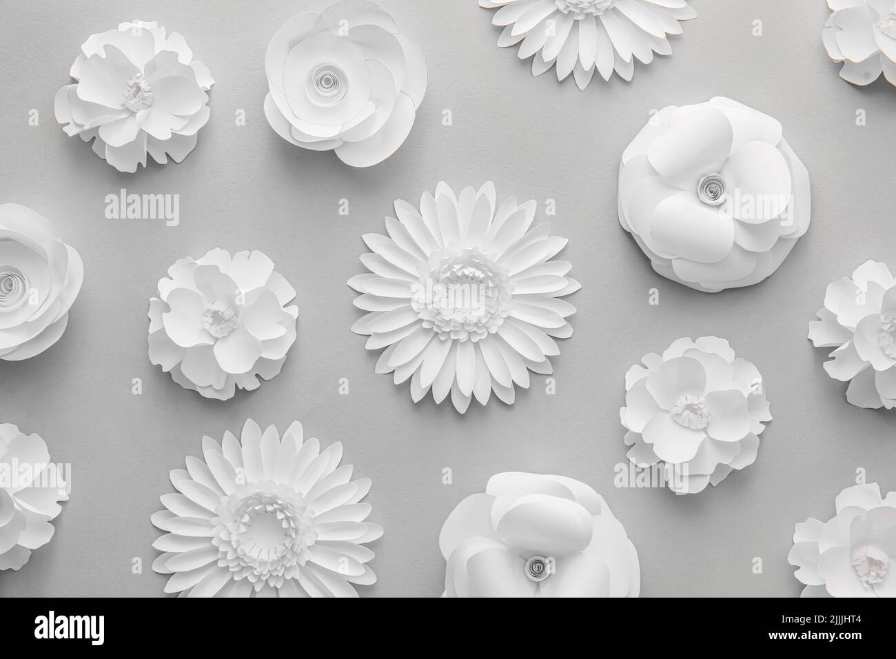 Different paper flowers on grey background Stock Photo - Alamy