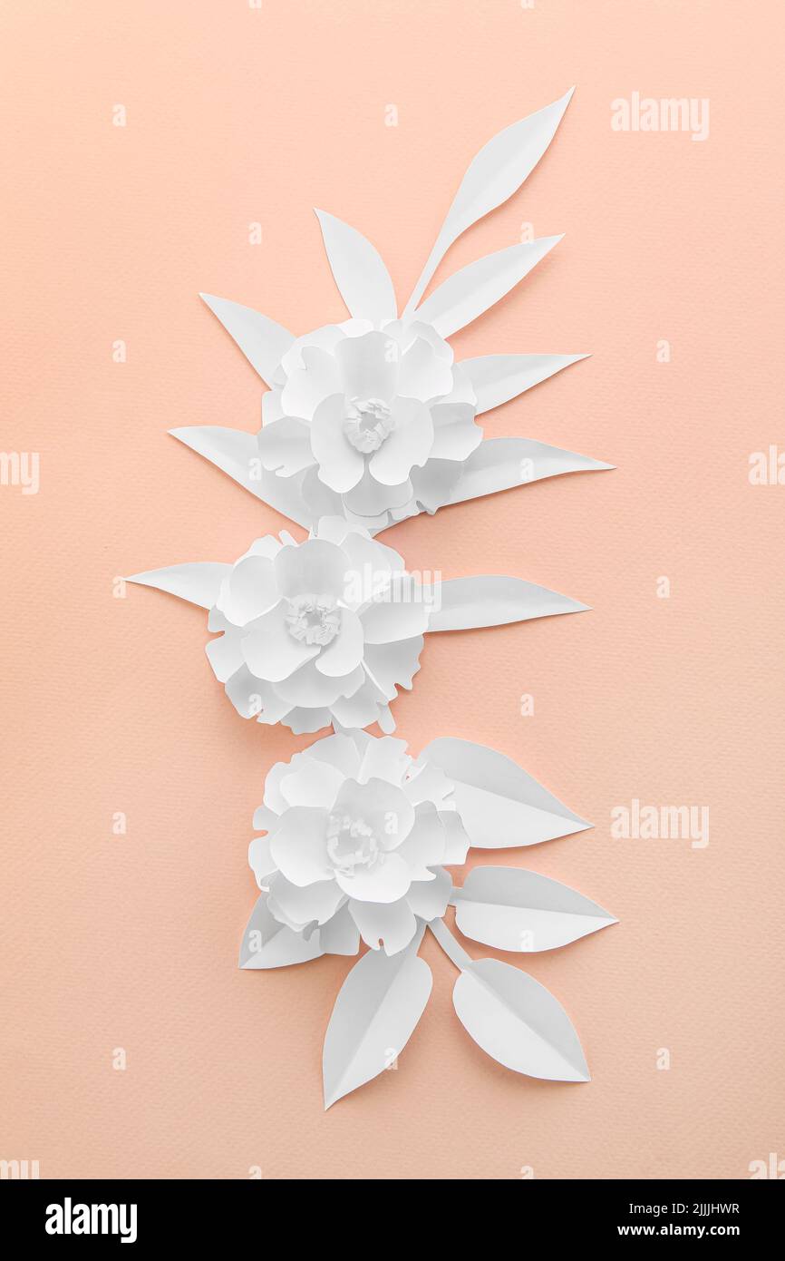 Composition with beautiful paper flowers and leaves on pink background ...