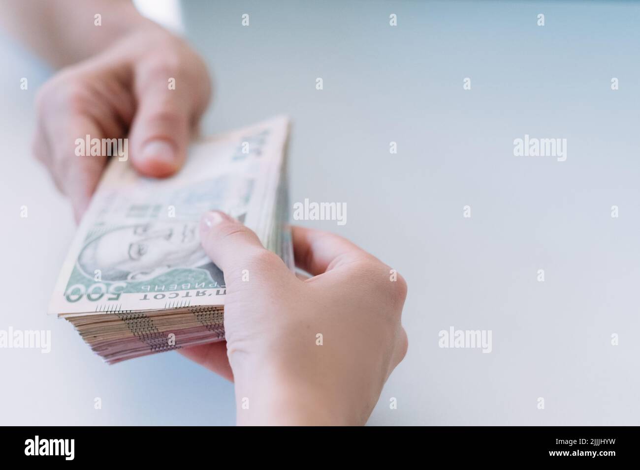 hands bundle money cash payment bribery hryvnia Stock Photo - Alamy