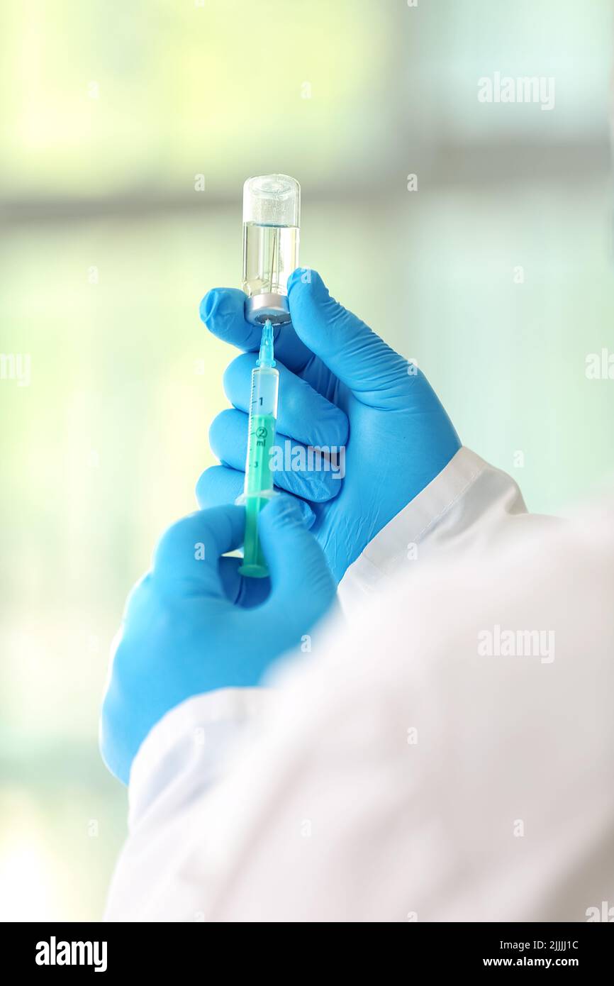 Doctor with ampule and syringe in clinic, closeup Stock Photo - Alamy