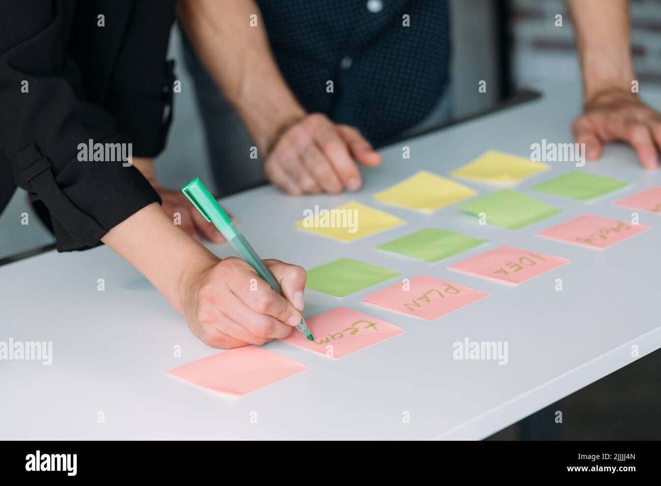 coworking office writing notes planning teamwork Stock Photo - Alamy