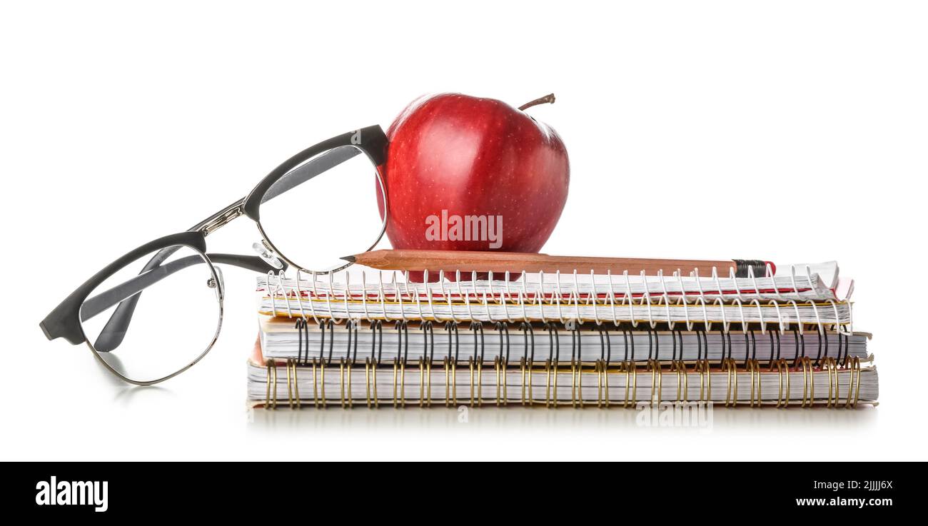 Notebooks with pencil, eyeglasses and apple on white background Stock ...