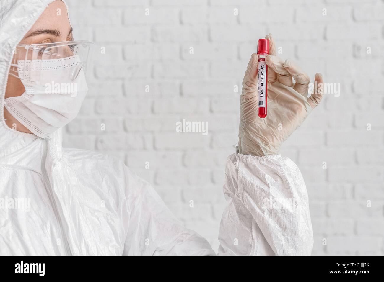 Scientist with sample of monkeypox virus on white background Stock ...