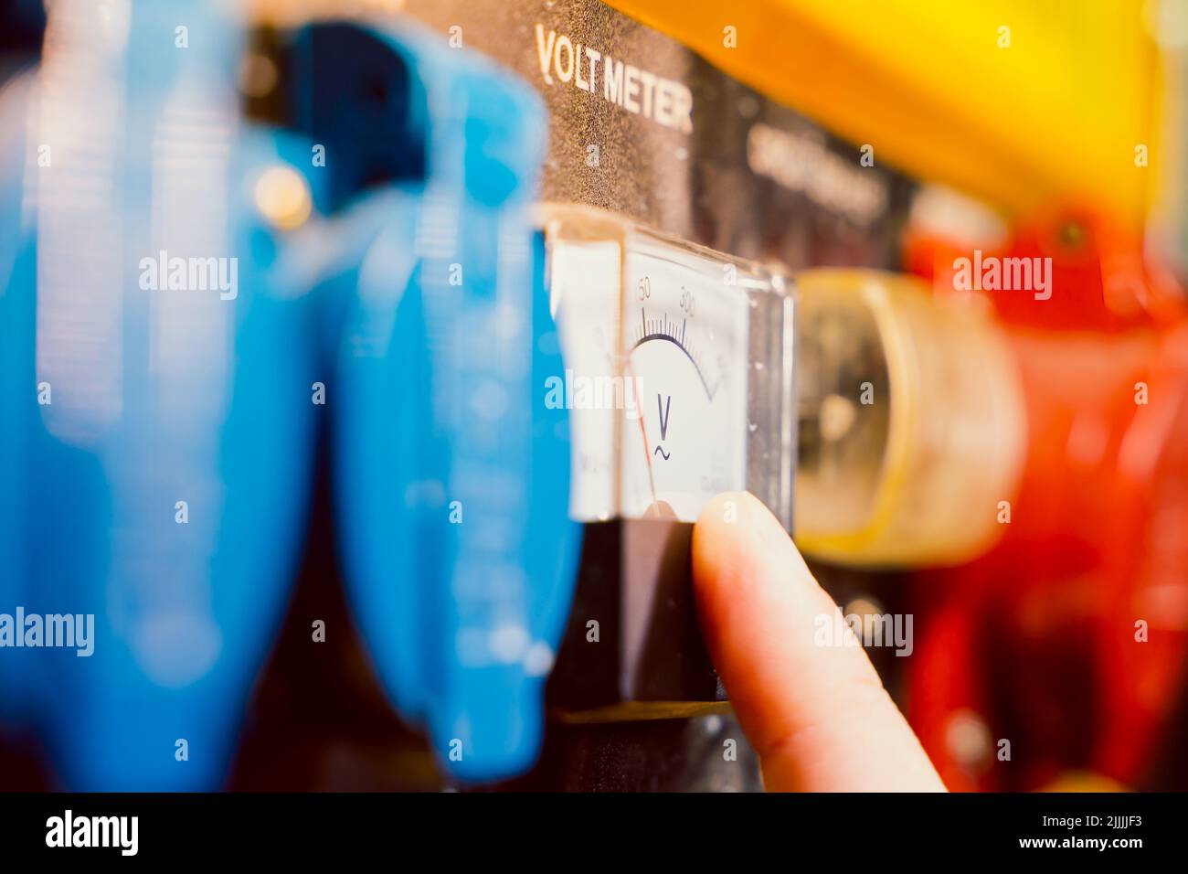 Voltmeter on the body of the gas generator close-up. Finger points to ...