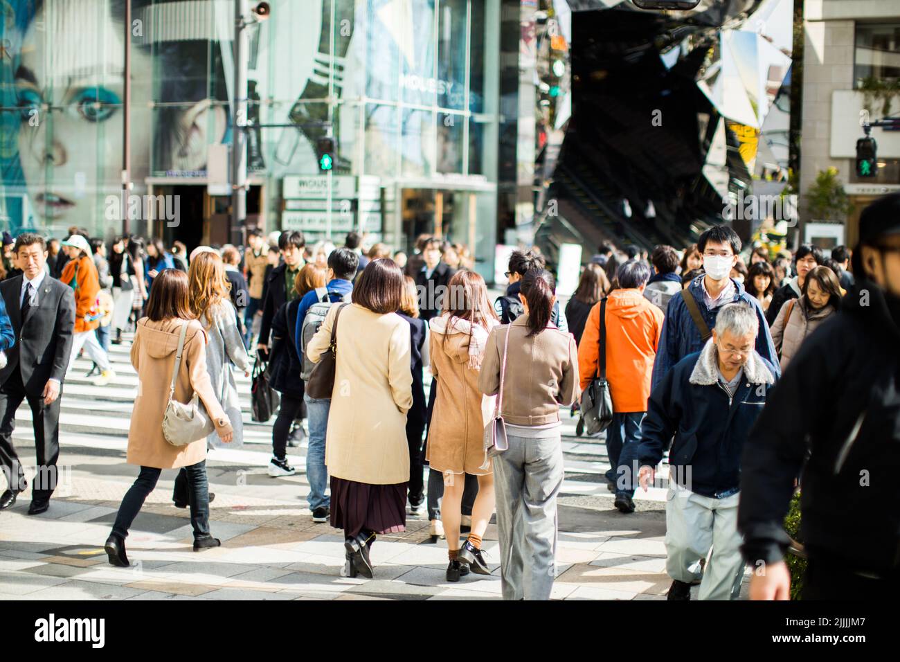 Crowds walking across the street Stock Photo - Alamy