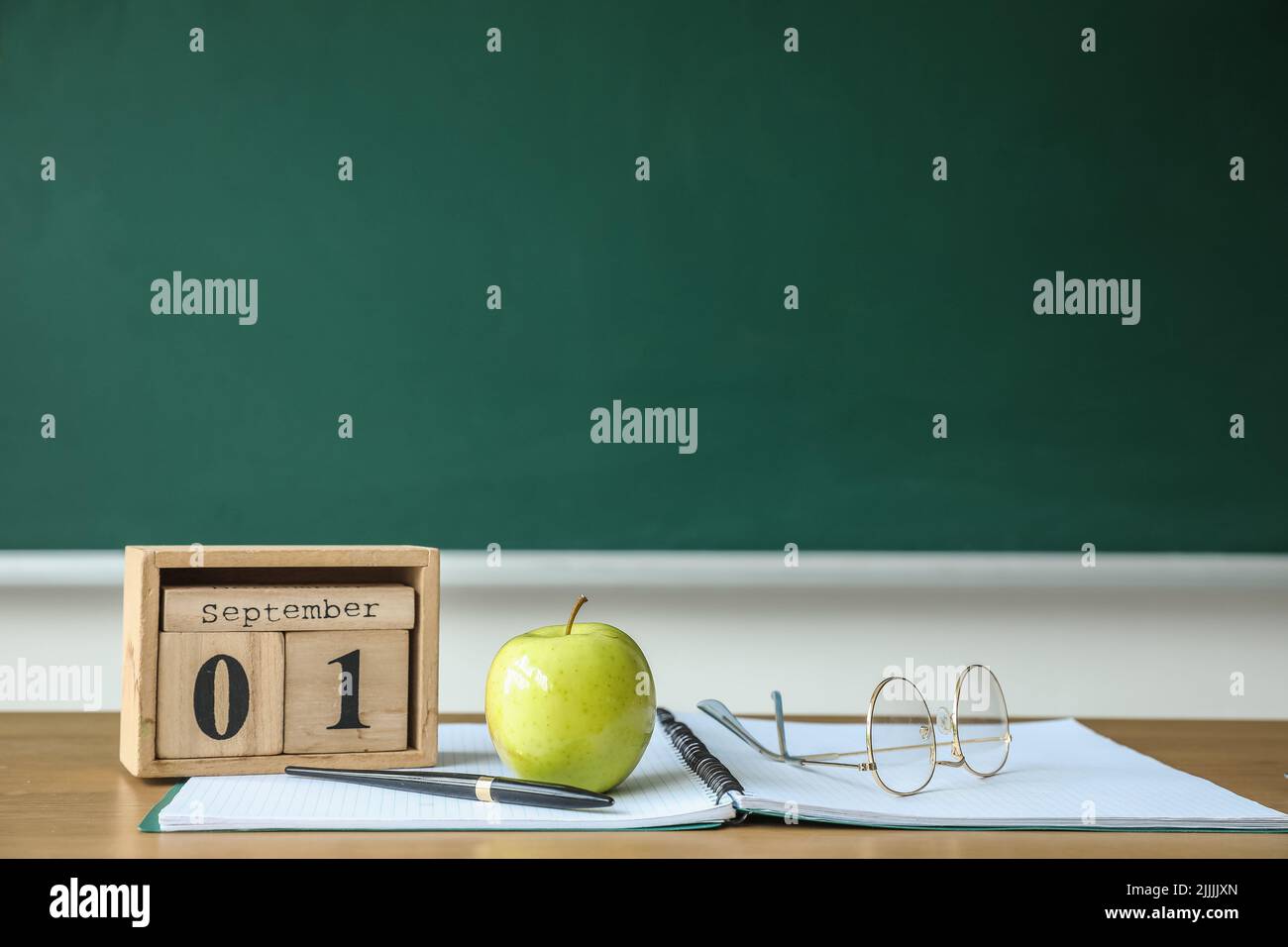 Cube calendar with date 1 SEPTEMBER, apple, eyeglasses and copybook on ...