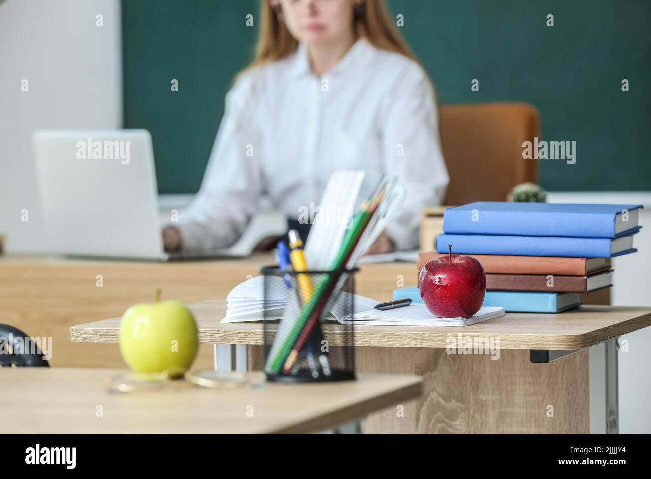 Red apple with school books on table in classroom Stock Photo - Alamy