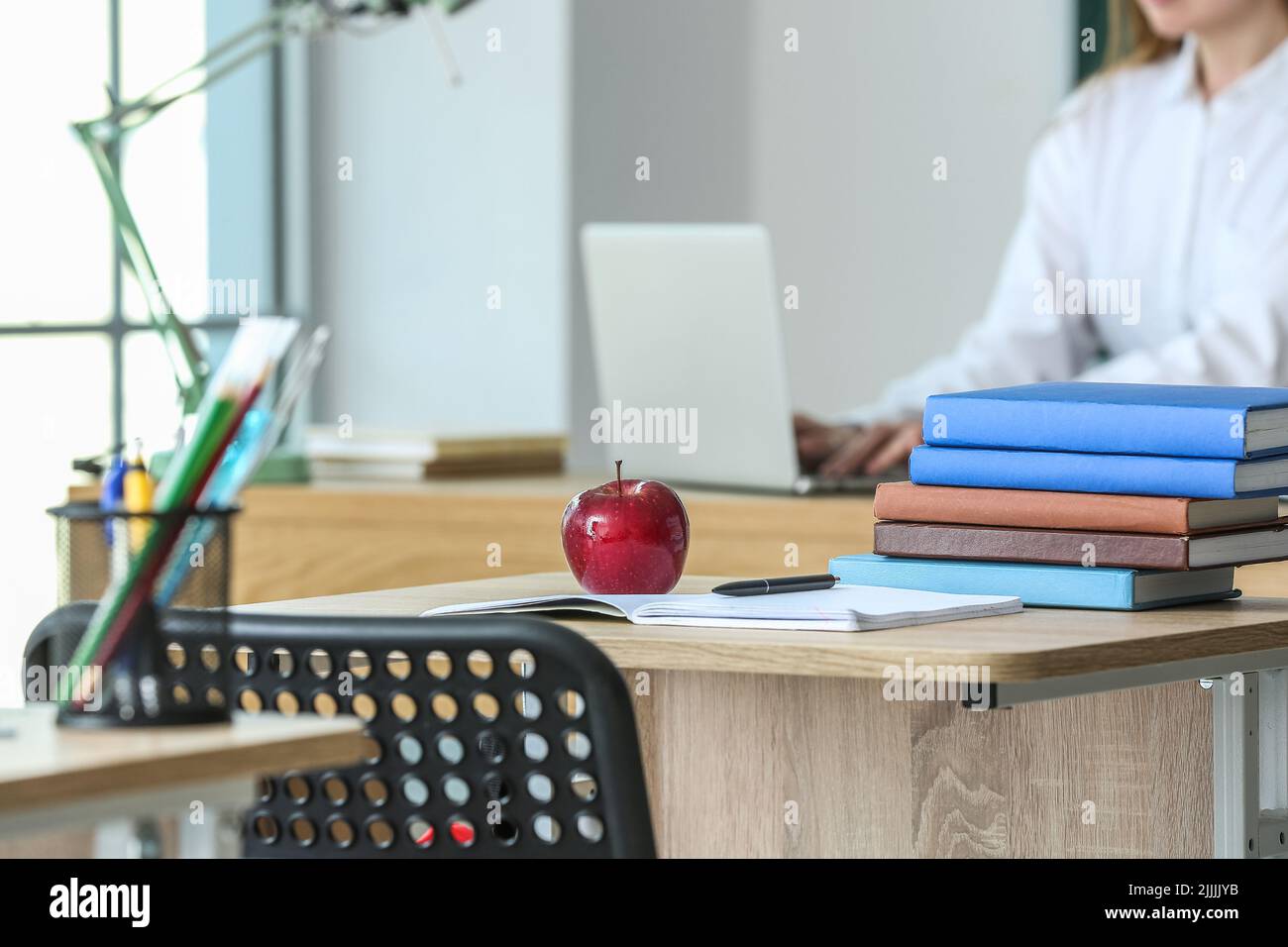 Red apple with school books on table in classroom Stock Photo - Alamy