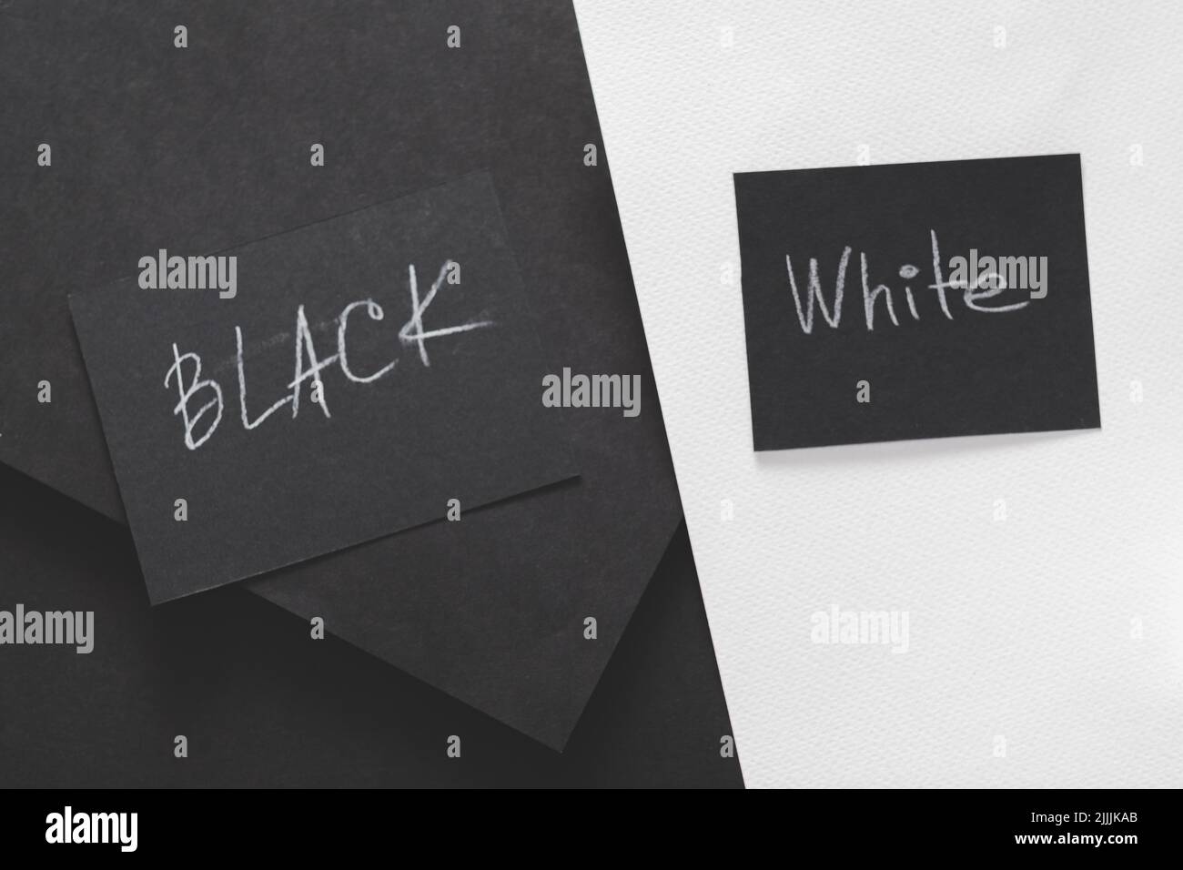 black white contrast comparison extremity paper Stock Photo - Alamy