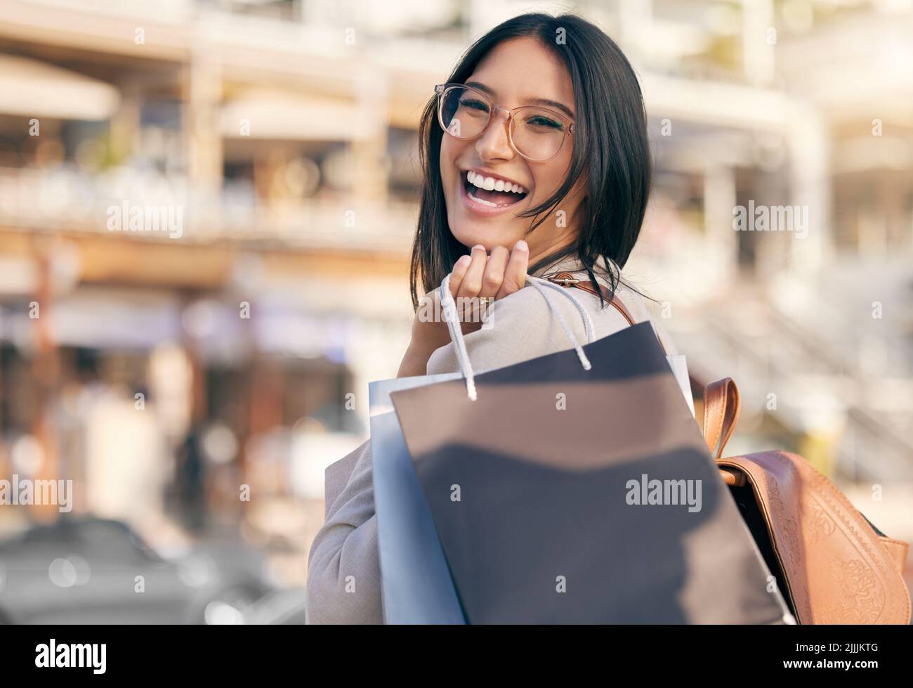 The gift of swiping. Portrait of an attractive young woman walking ...