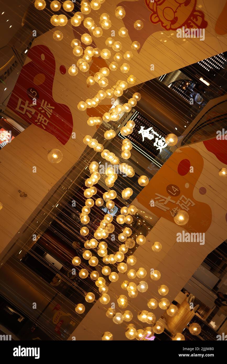A row of light bulbs hanging in a mall Stock Photo - Alamy