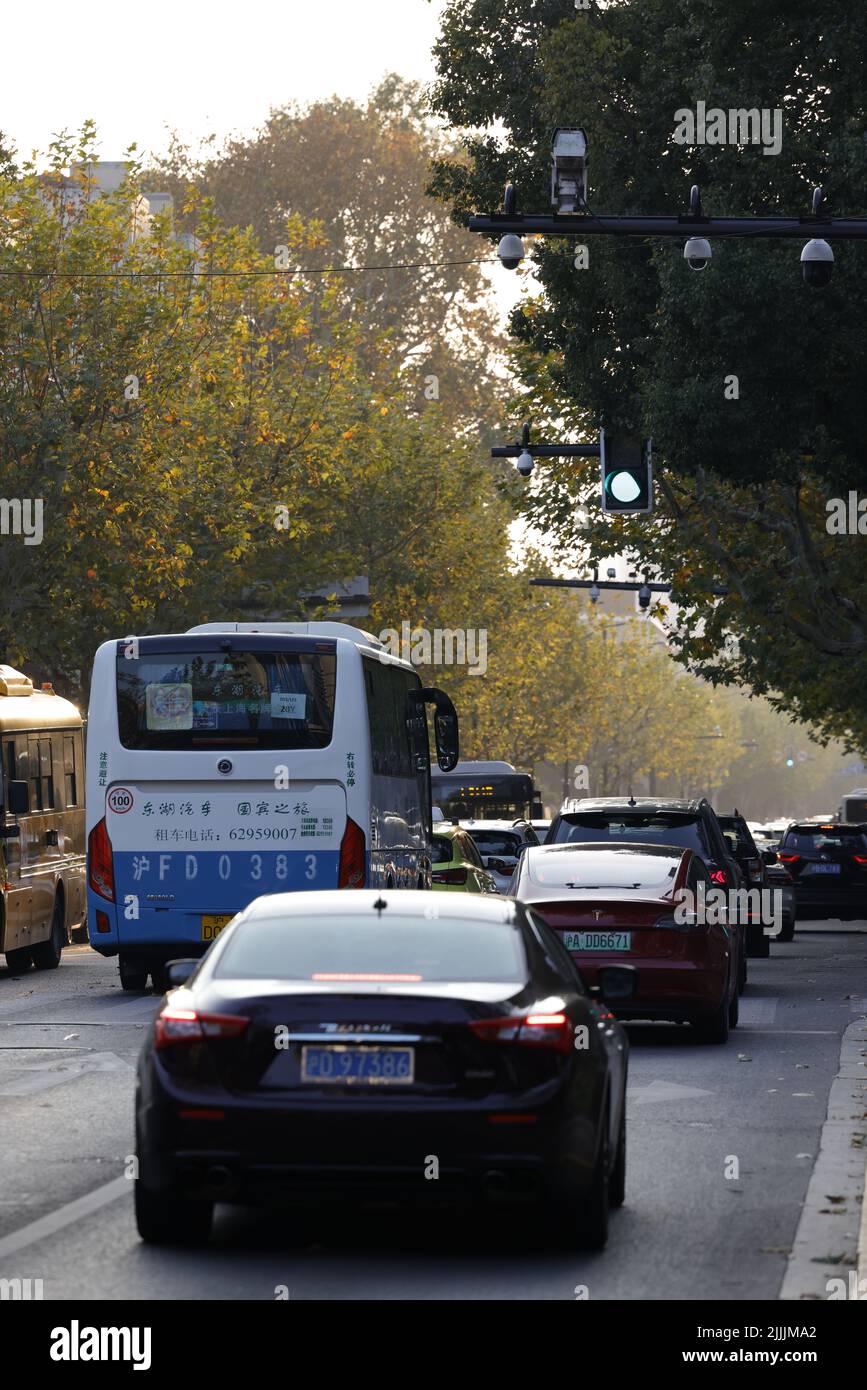 A view of cars and buses on a traffic road with trees Stock Photo - Alamy