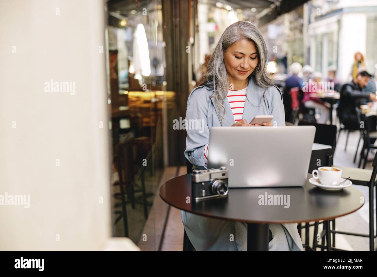 Confident Asian businesswoman networking in coffee shop Stock Photo - Alamy