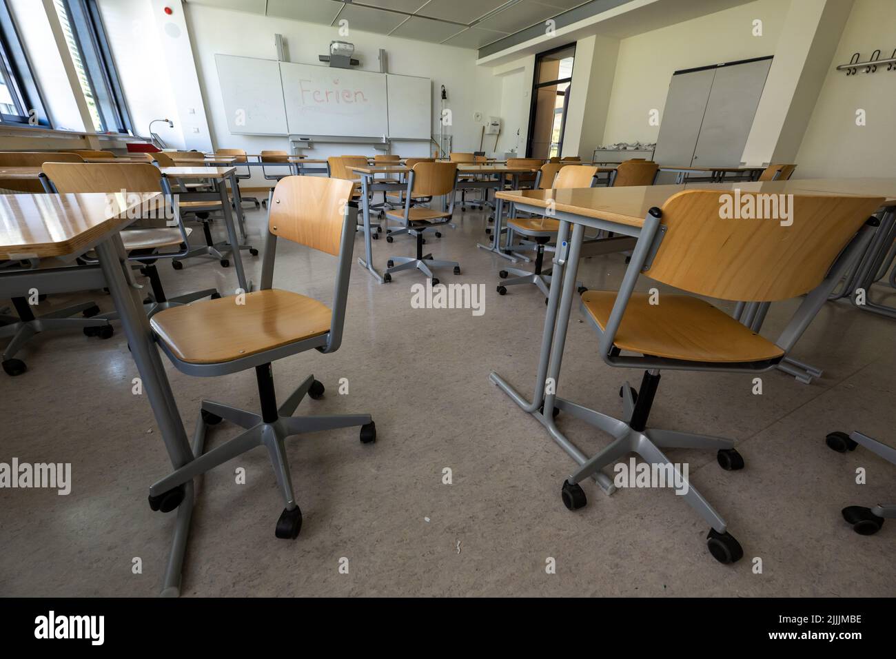 Munich, Germany. 19th July, 2022. Chairs stand in an empty classroom at ...