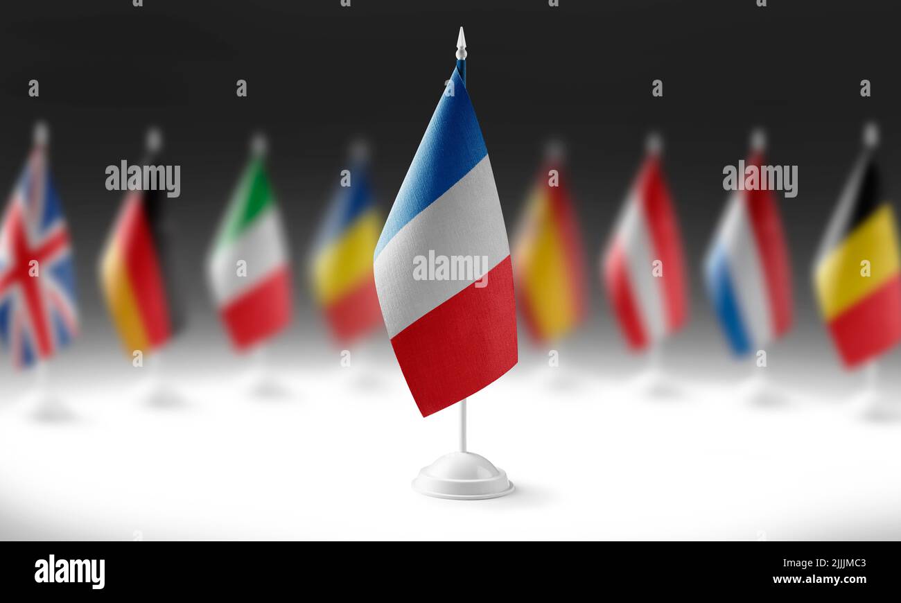 The national flag of the France on the background of flags of other ...
