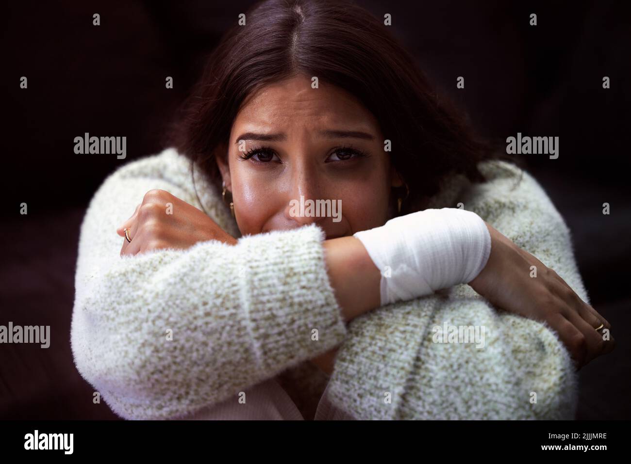 Pain is a prison for the mind. a young woman sitting on the floor and ...