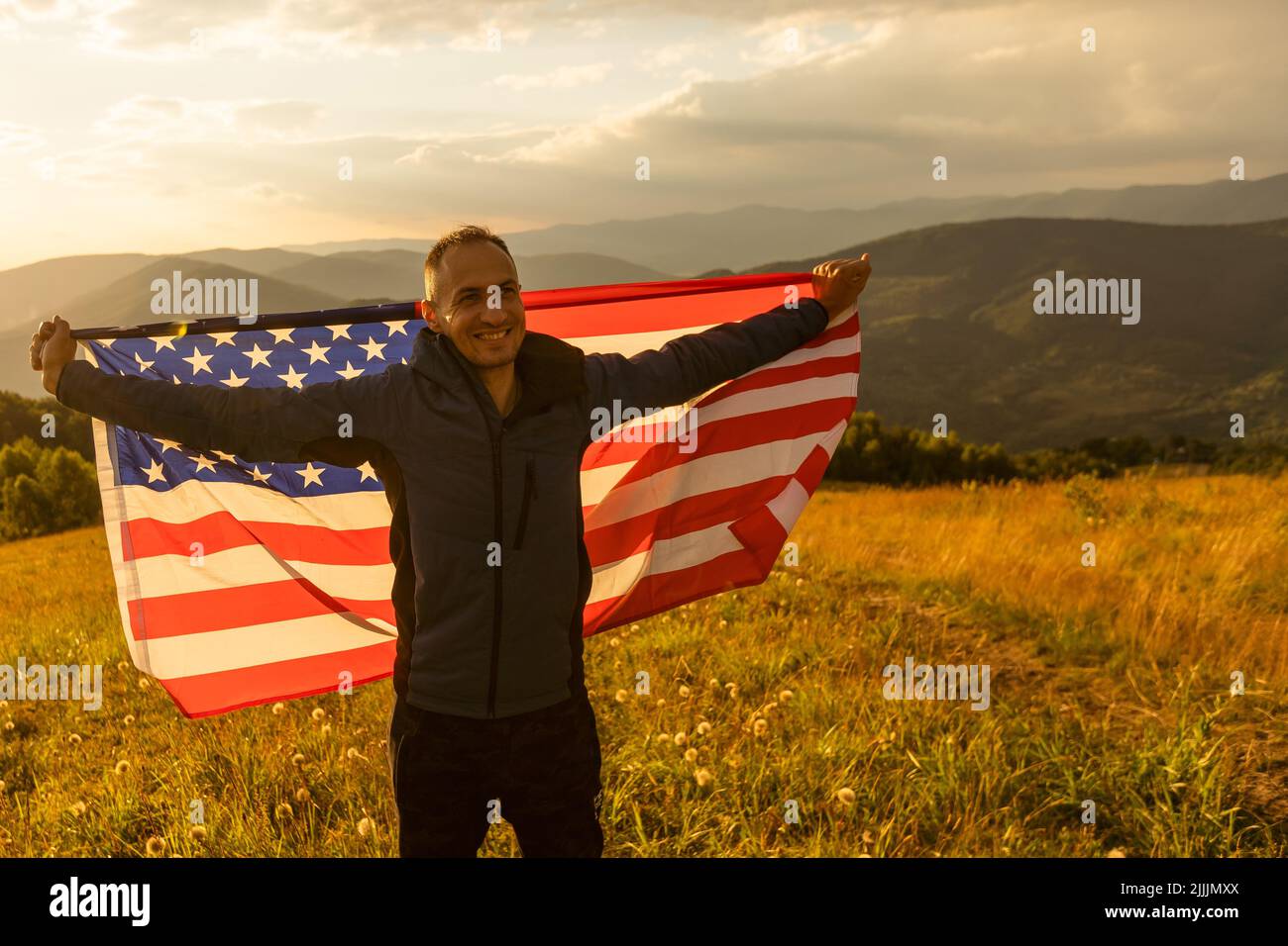 man holding an american flag Stock Photo - Alamy