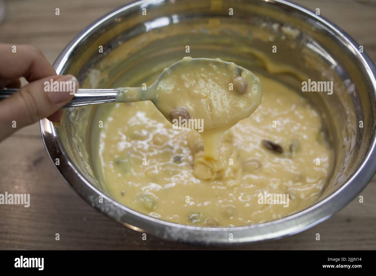 Kneading dough on a muffin or cake with raisins Stock Photo - Alamy