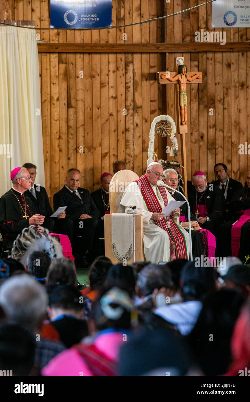 One of the priests assists Pope Francis in reading his missil. The pope ...