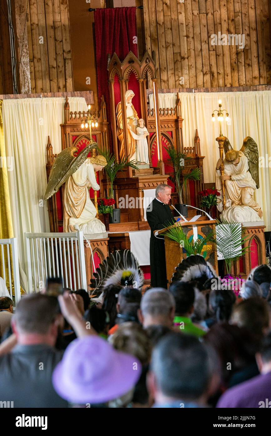 One of the priests assists Pope Francis in reading his missil. The pope ...