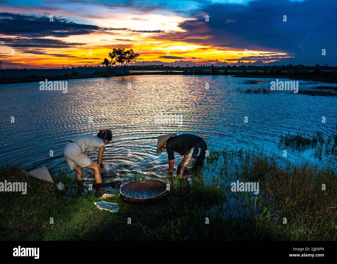 Daughter and Mom cleaning farming tools at sunset Stock Photo - Alamy